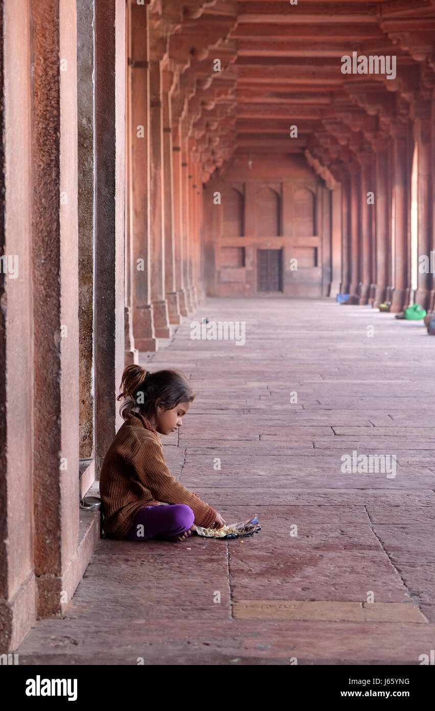 A poor girl eating in Fatehpur Sikri complex, Uttar Pradesh, India on ...