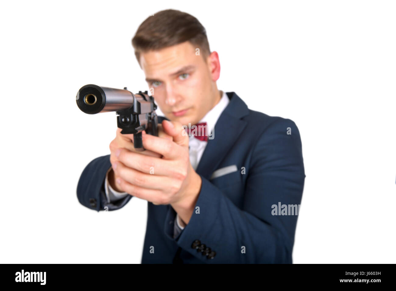 Confident businessman pointing a gun on isolated background Stock Photo ...