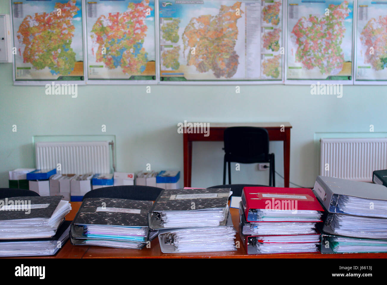 Working folders in the office with maps on the wall. Working atmosphere ...