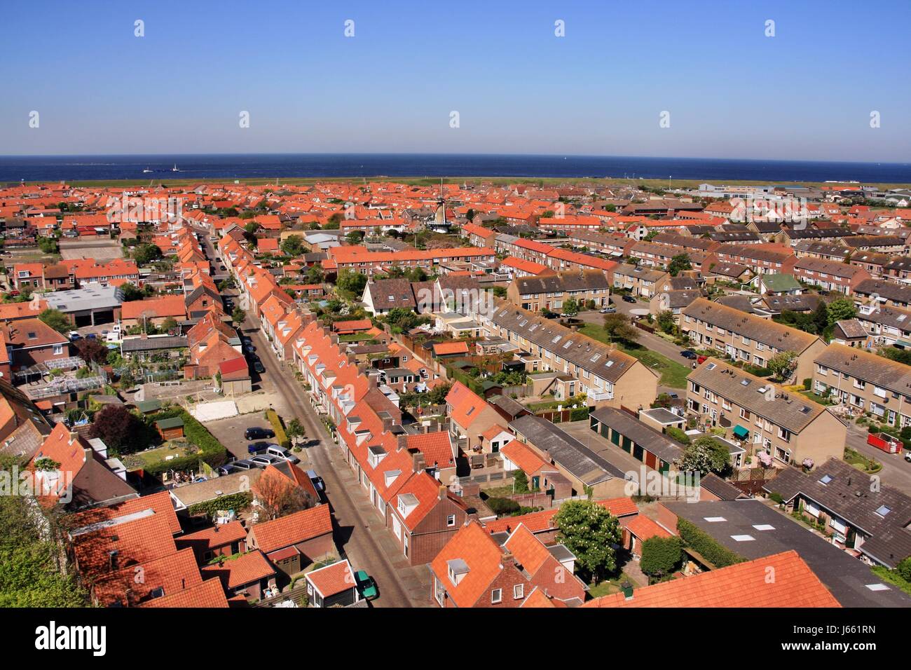 blue roofs brick salt water sea ocean water red blue house building ...
