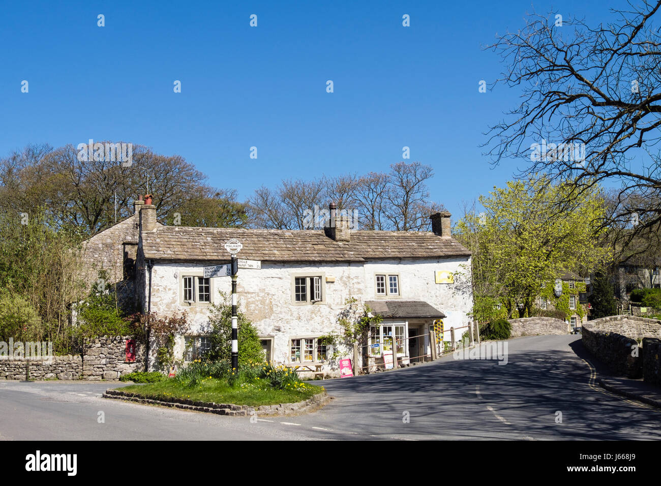 Malham village shop and signpost at road junction in picturesque ...