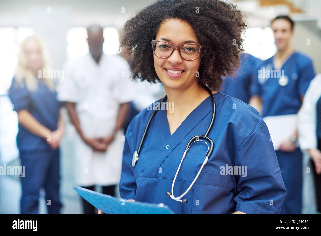 Pretty young African American medical professional standing and looking ...