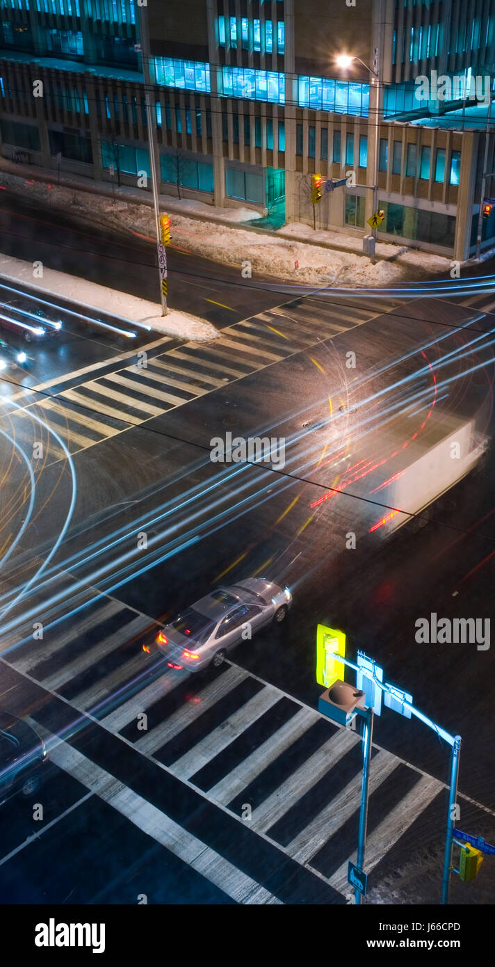 night nighttime intersection light blue house building city town green ...