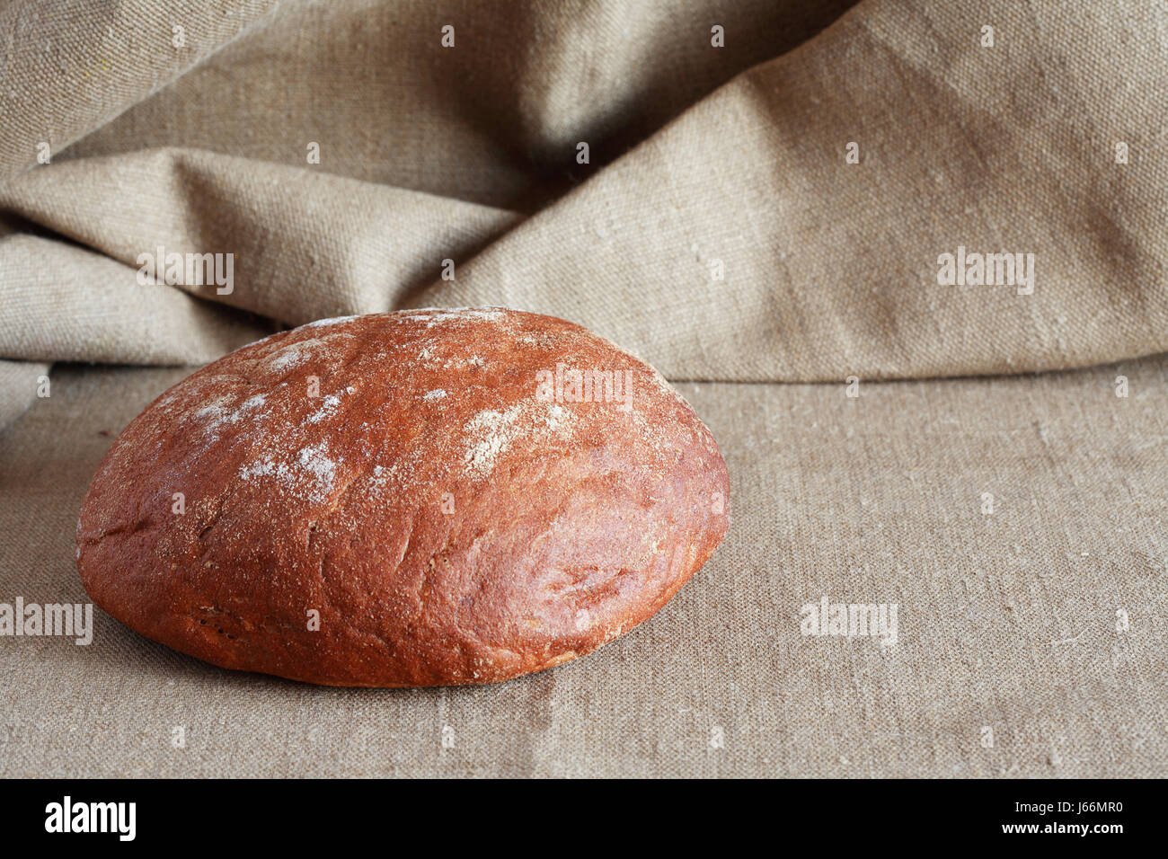 Round rye bread lying on canvas surface with free space for text Stock ...