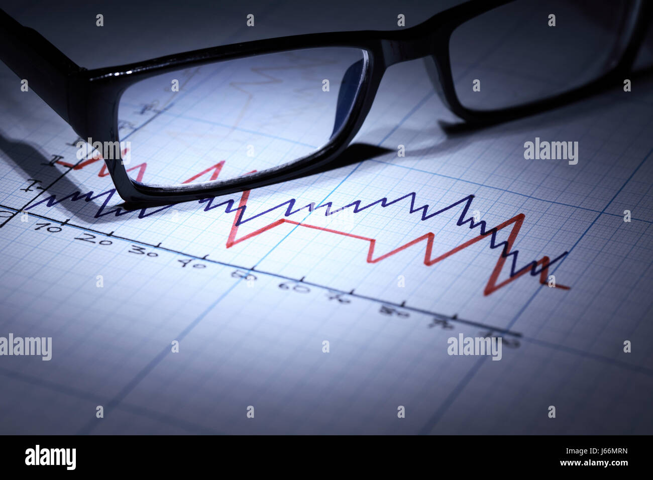 Business concept. Closeup of spectacles on graph paper with diagram ...