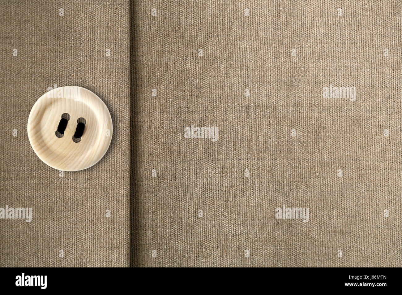 Wooden button with black thread on canvas background Stock Photo - Alamy