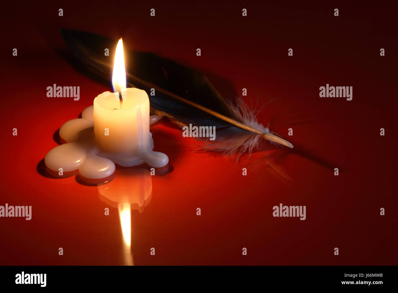 Writing concept. Vintage still life with quill pen near lighting candle ...