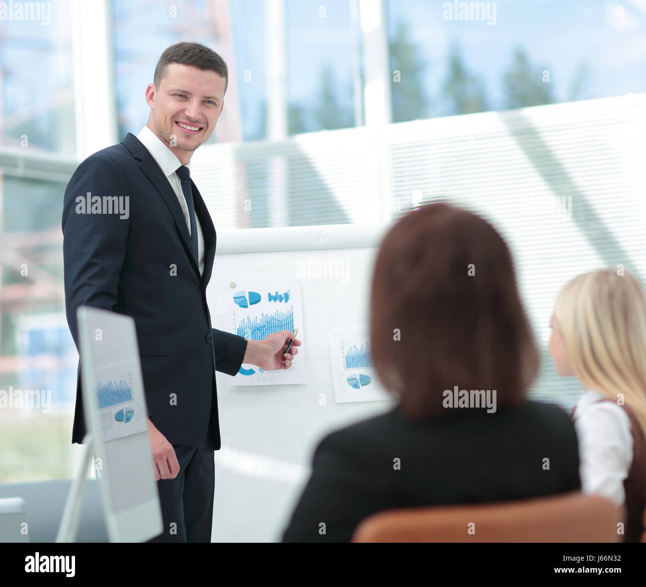 Attractive man making a business presentation to a group Stock Photo ...