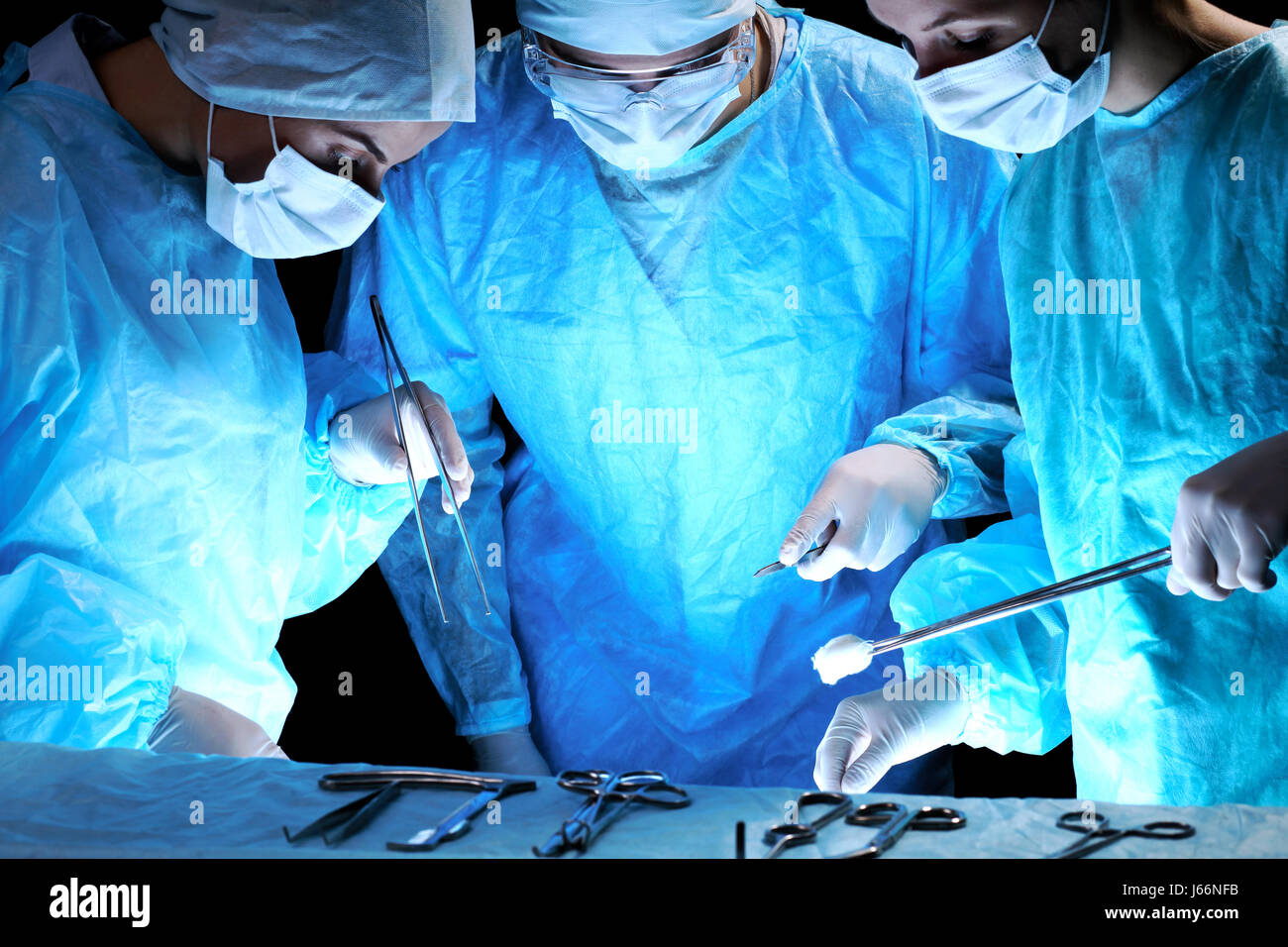 Medical team performing operation. Group of surgeon at work in ...