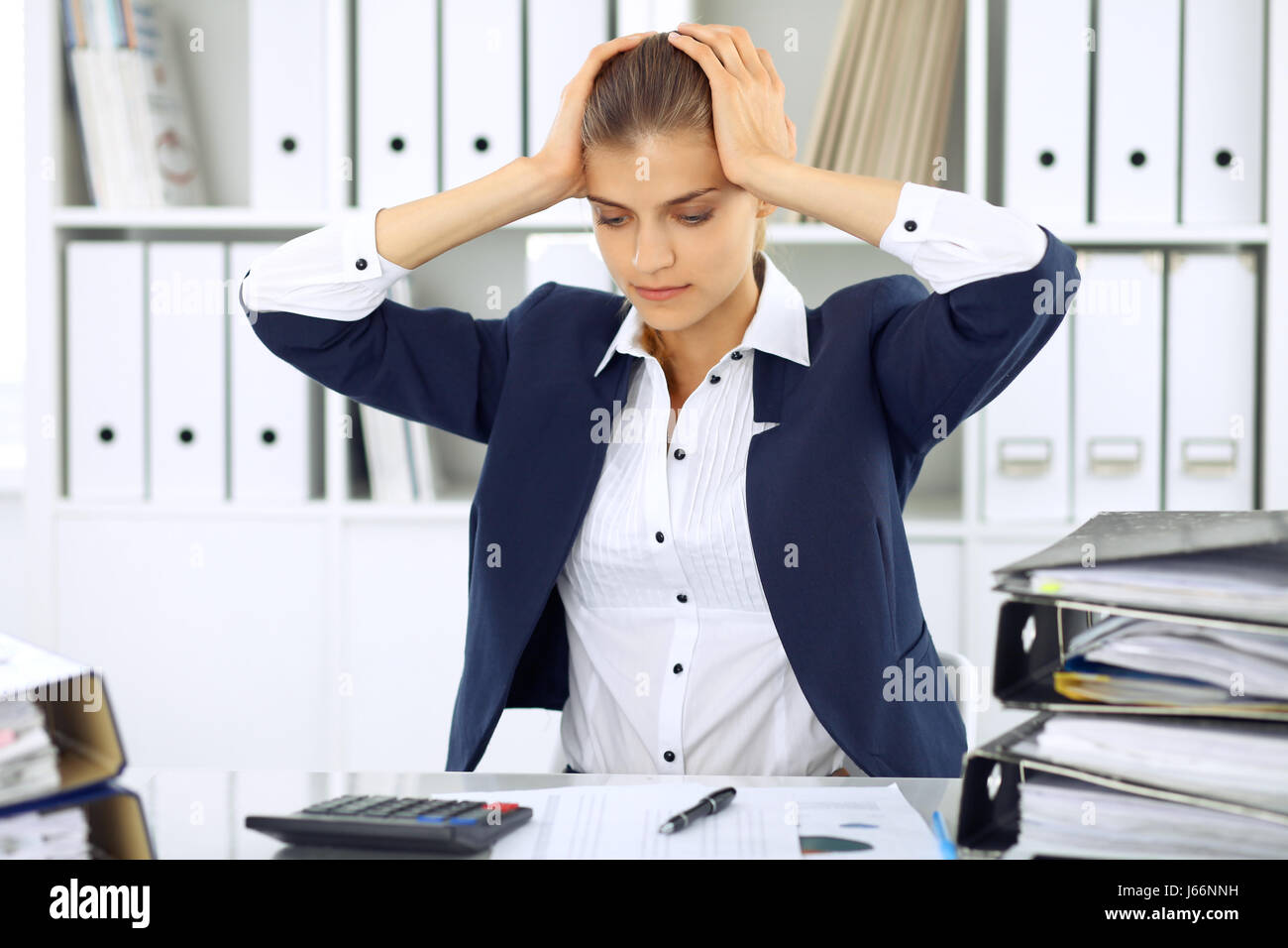 Tired business woman or female accountant with bills and paper folders ...