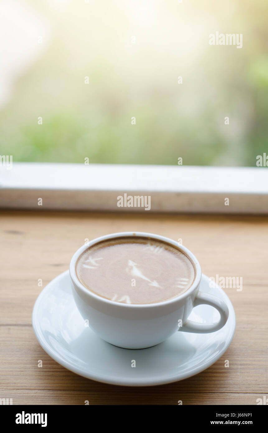 latte art coffee in green nature background Stock Photo - Alamy