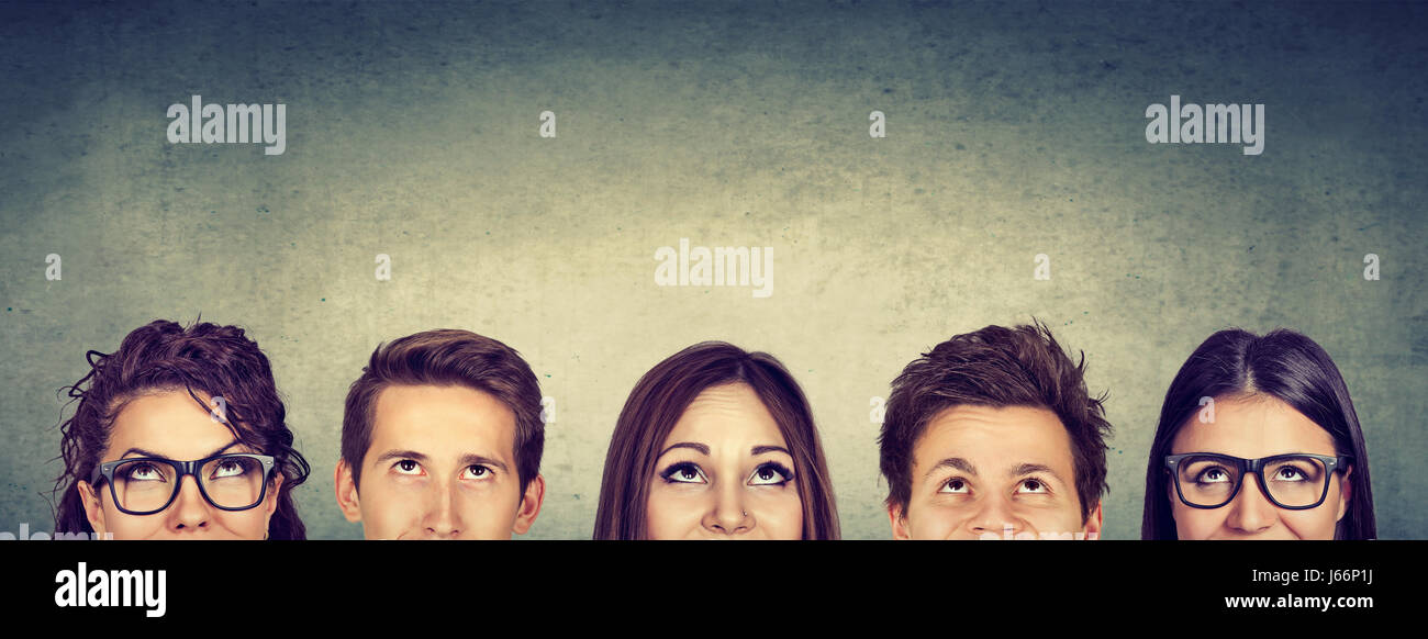 Thoughtful group of people looking up Stock Photo - Alamy