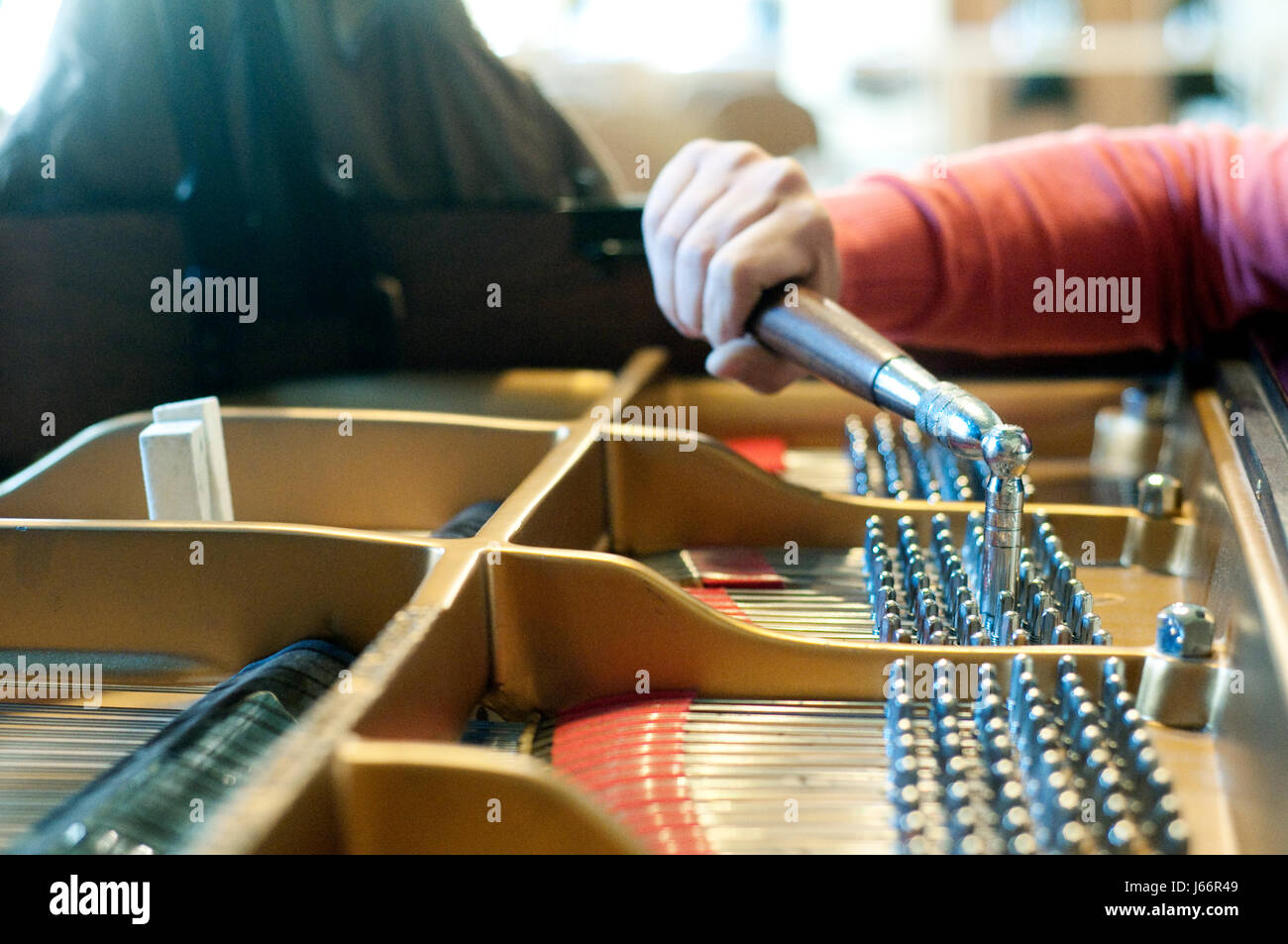 Hand of a Man Piano Tuner Tuning a Grand Piano Stock Photo - Alamy