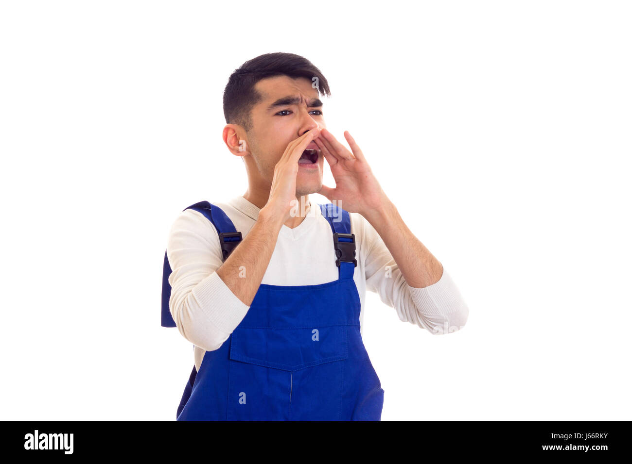 Young man in blue overall shouting Stock Photo - Alamy
