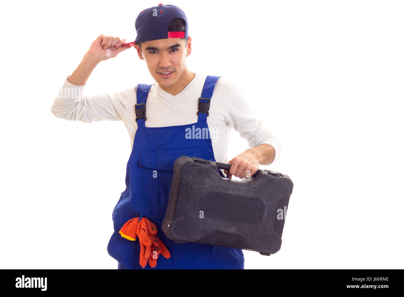 Young man in overall holding toolbox Stock Photo - Alamy