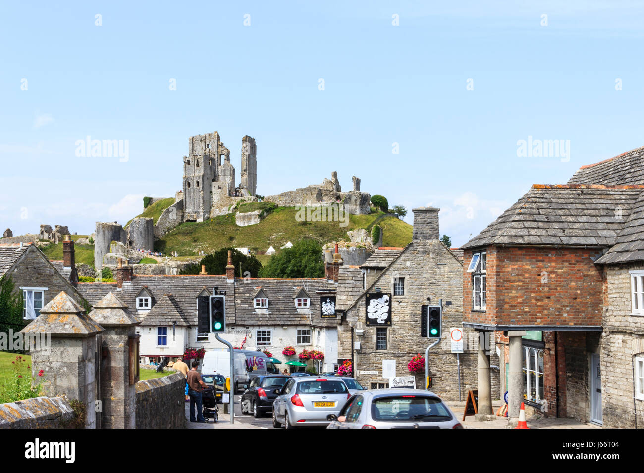 The village of Corfe Castle, with a view of the old castle ruins in the ...