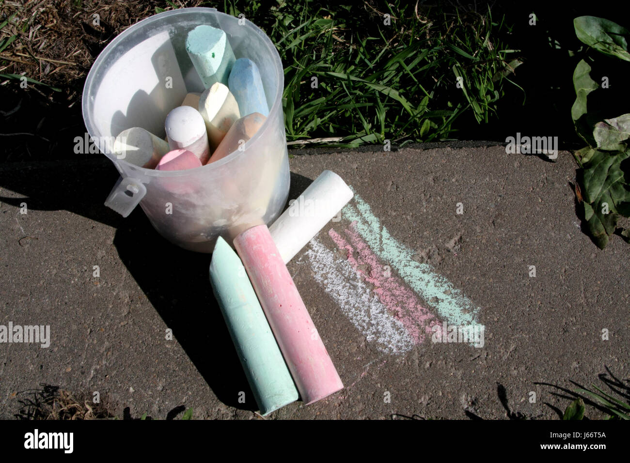 Capacity with outdoor colored chalk is on the pavement and near are ...