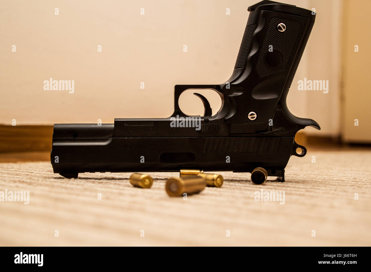 Gun on the floor, crime, the shell of the bullets next to the gun ...