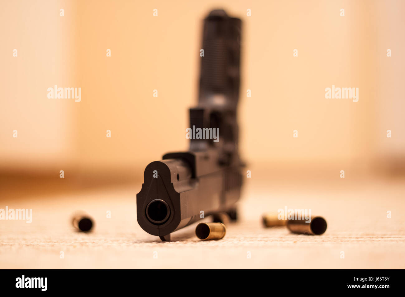 Gun on the floor, crime, the shell of the bullets next to the gun ...