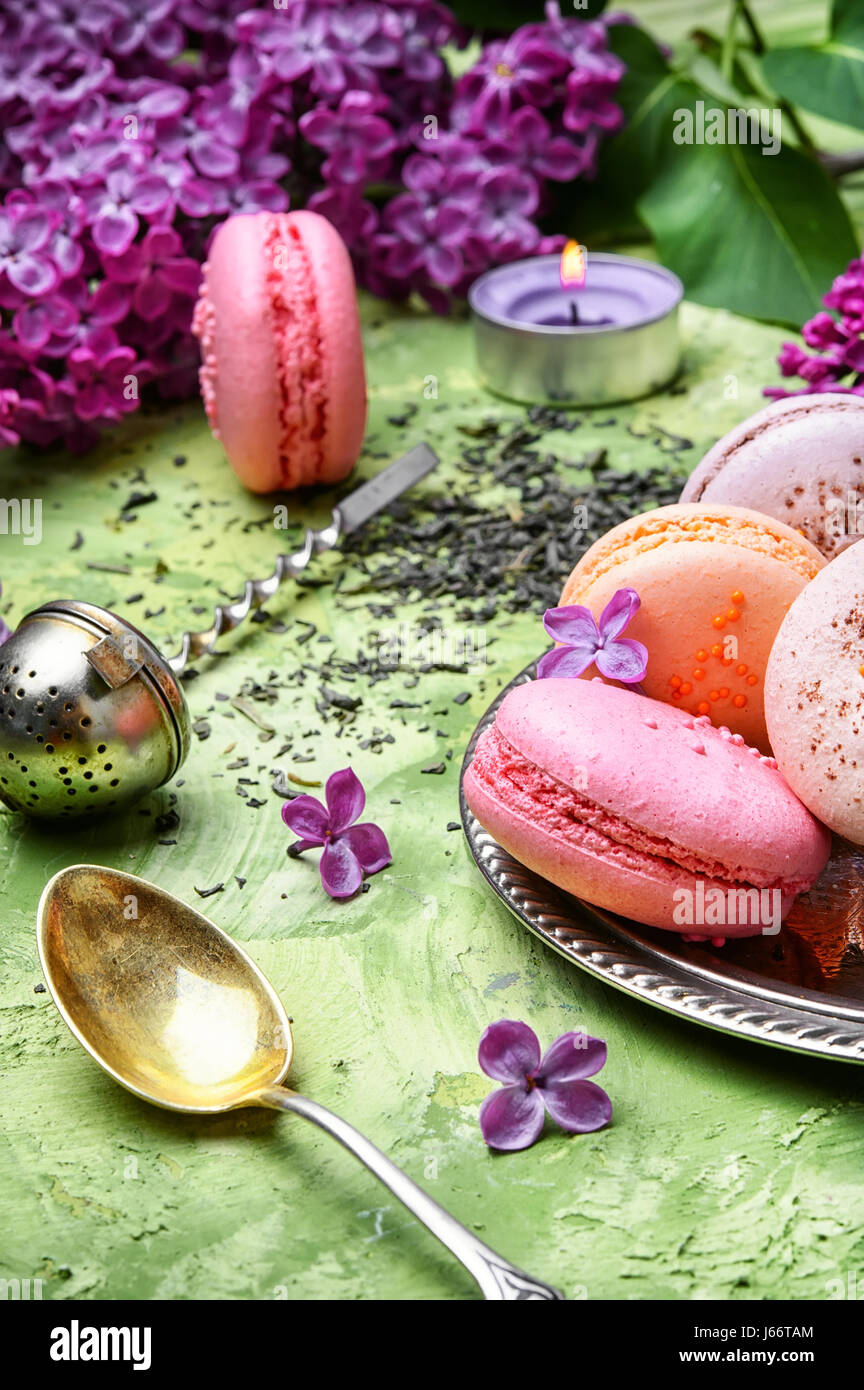 macarons cake and branch of springtime lilac blossoms Stock Photo - Alamy