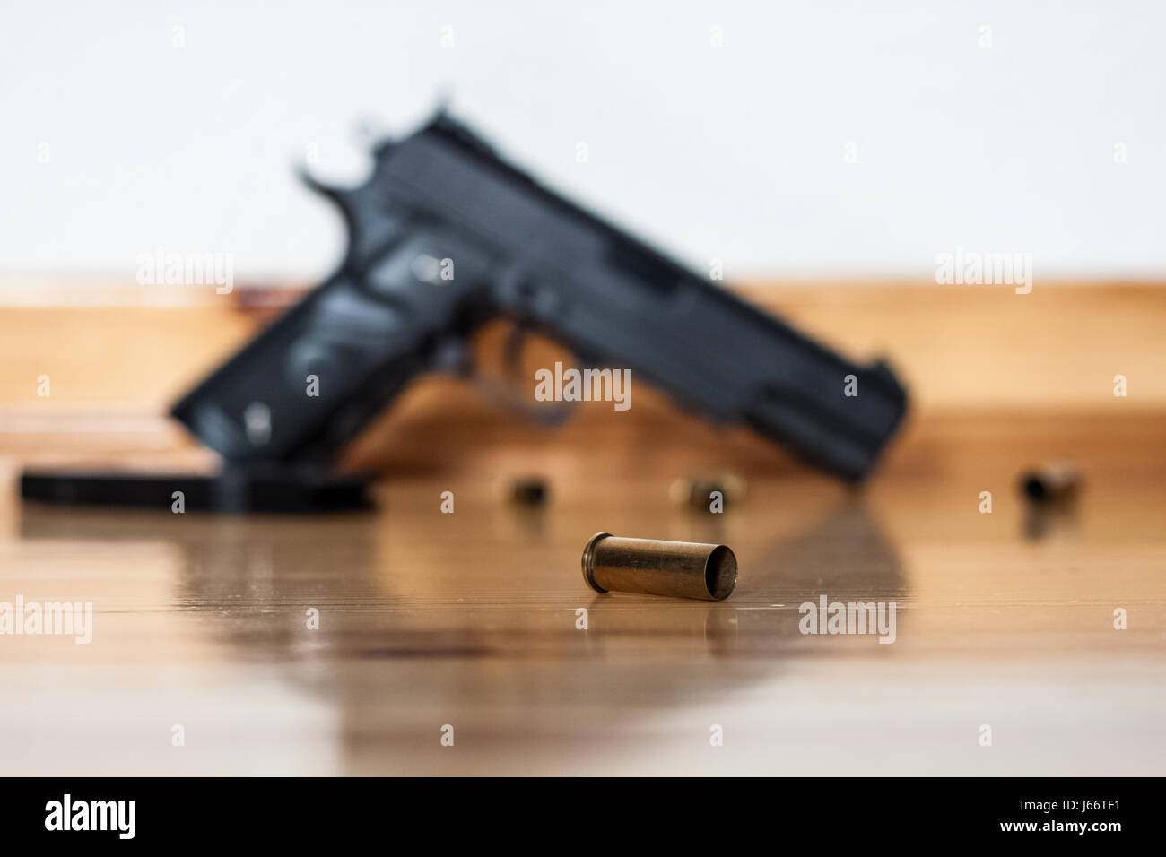 Gun on the floor, crime, the shell of the bullets next to the gun ...