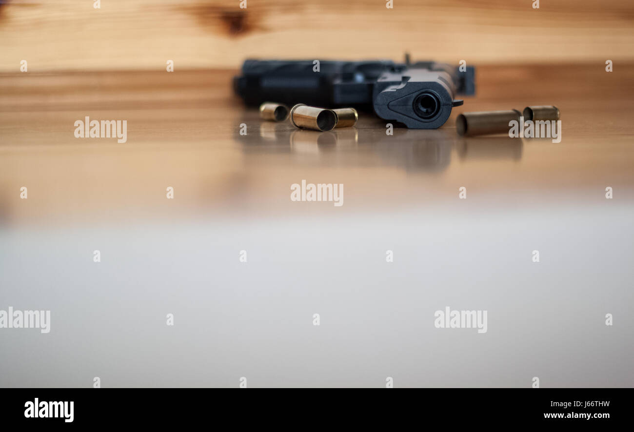 Gun on the floor, crime, the shell of the bullets next to the gun ...