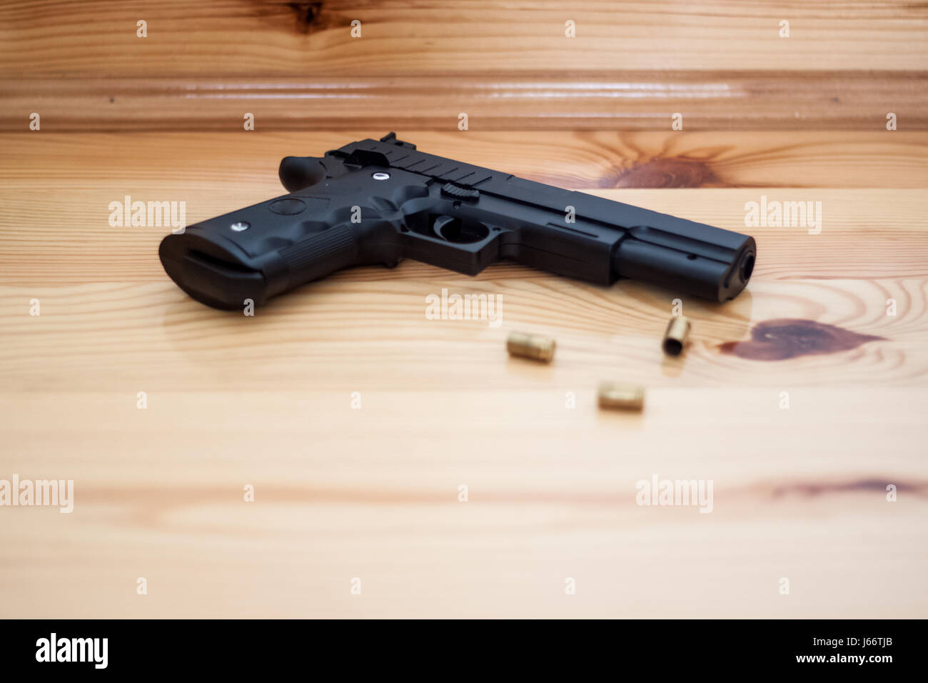 Gun on the floor, crime, the shell of the bullets next to the gun ...