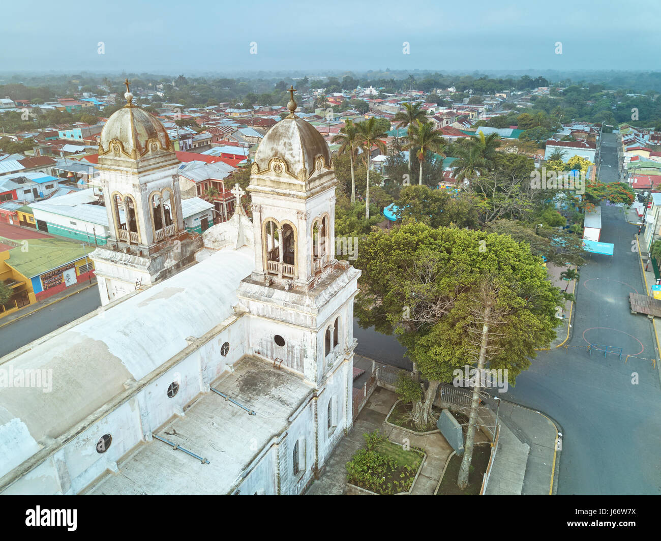 Central park in Diriamba town in morning. Roof of old cathedral church ...