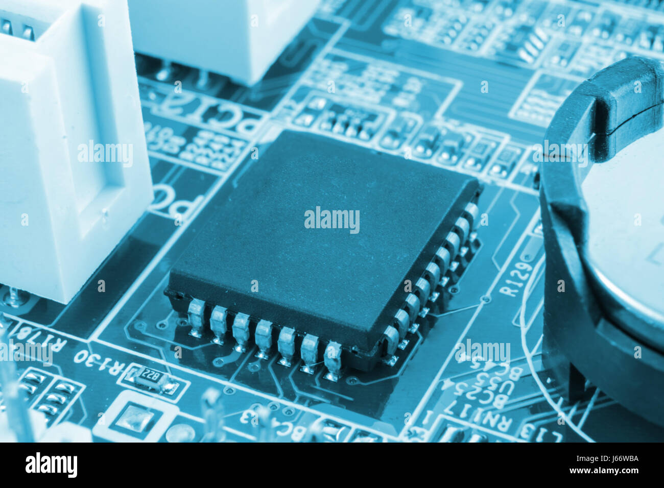 Chip on motherboard mainboard with controllers, ports and wires, close ...
