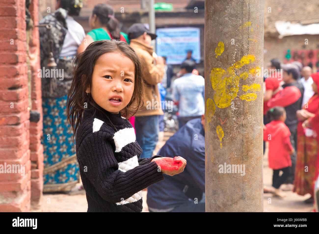 Kathmandu, Nepal - Apr 15, 2016: Little girl doing mischief with red ...