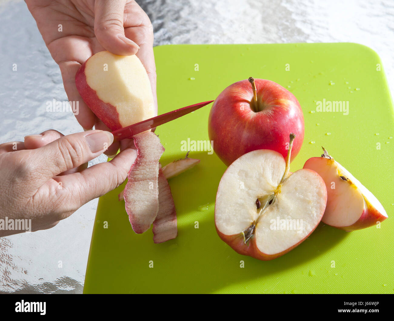 hand sliced apples peel in kitchen room Stock Photo - Alamy