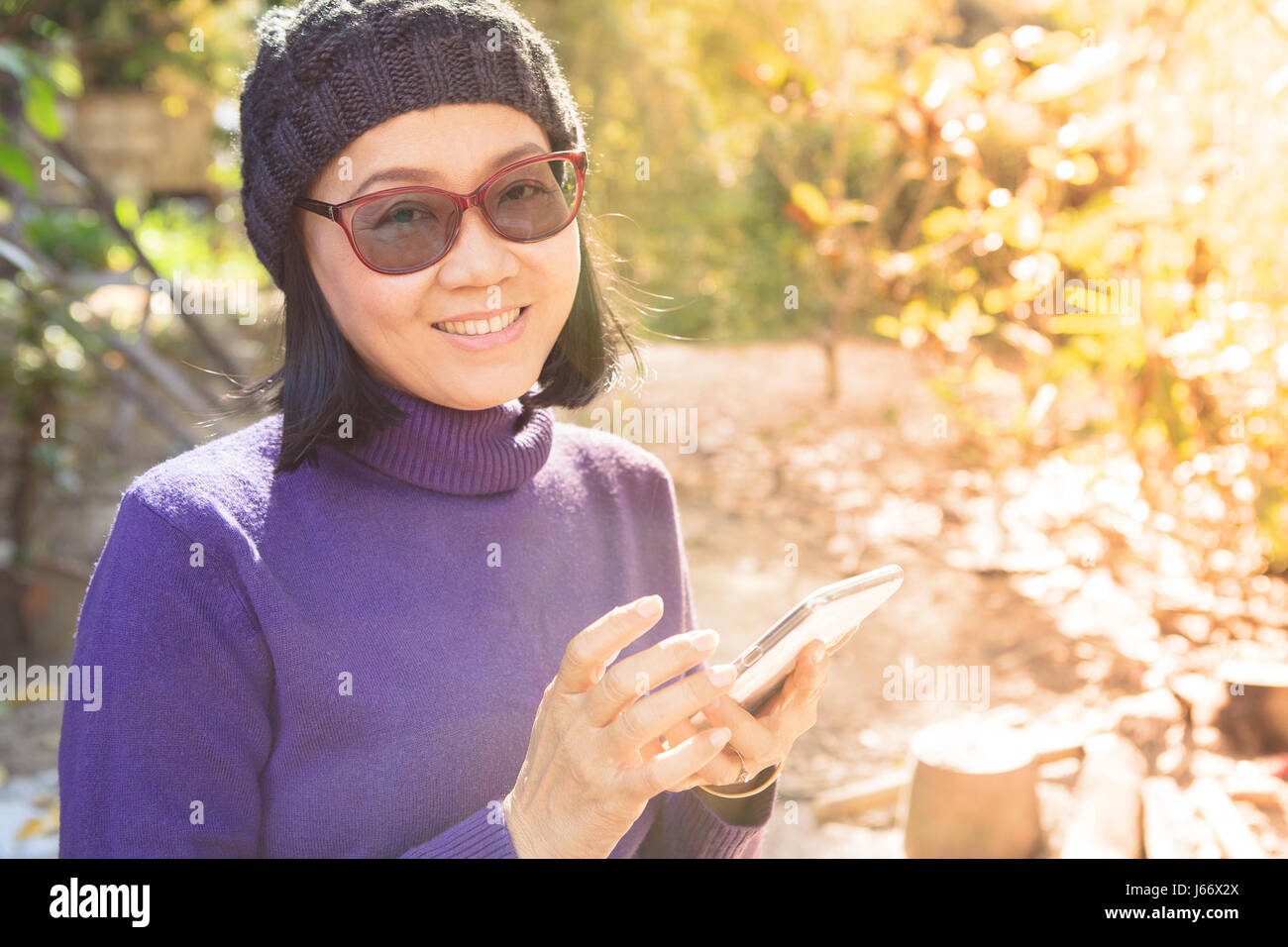 asian woman with smiling face happiness emotion and smart phone in hand ...