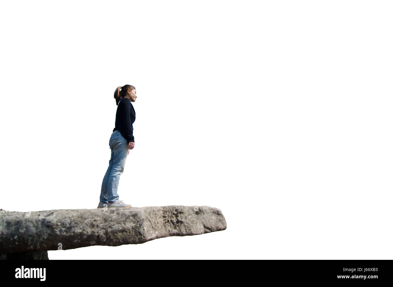 Young happy woman standing on cliff's edge isolated on white background ...