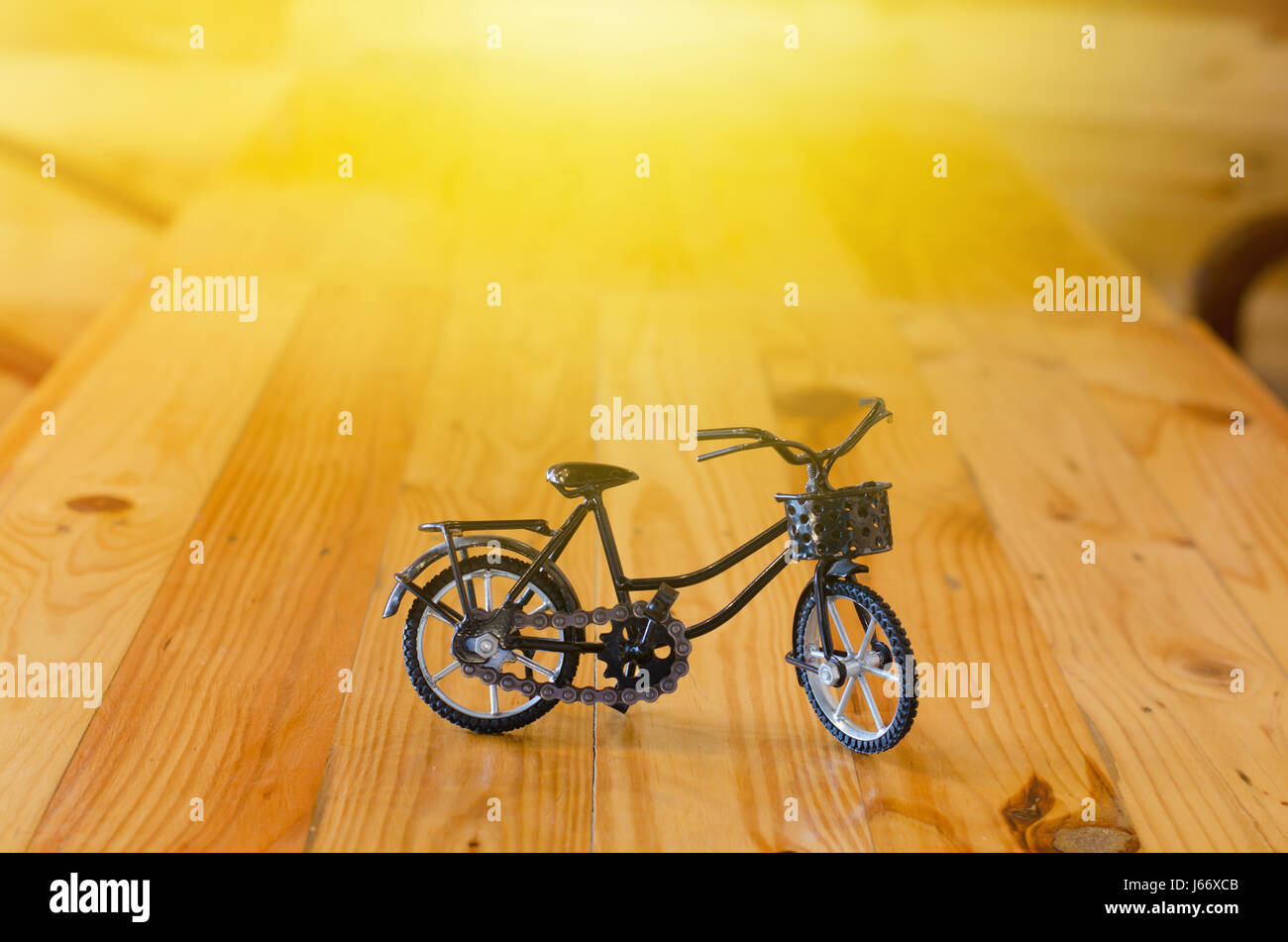 Small toy, bicycle model on wooden background Stock Photo - Alamy