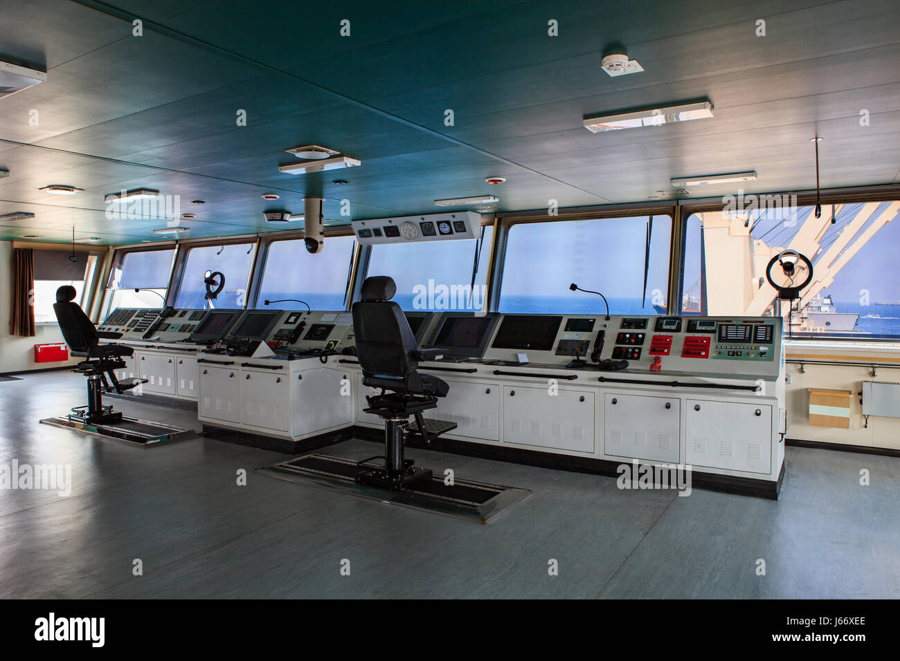 wheelhouse control board of modern industry ship approaching to harbor ...