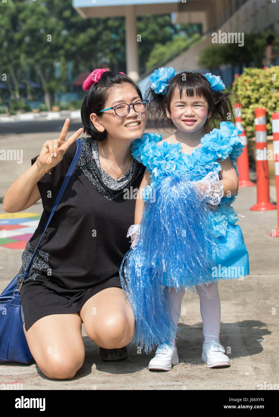 mother and young kid daughter wearing cheer leader dressing in ...
