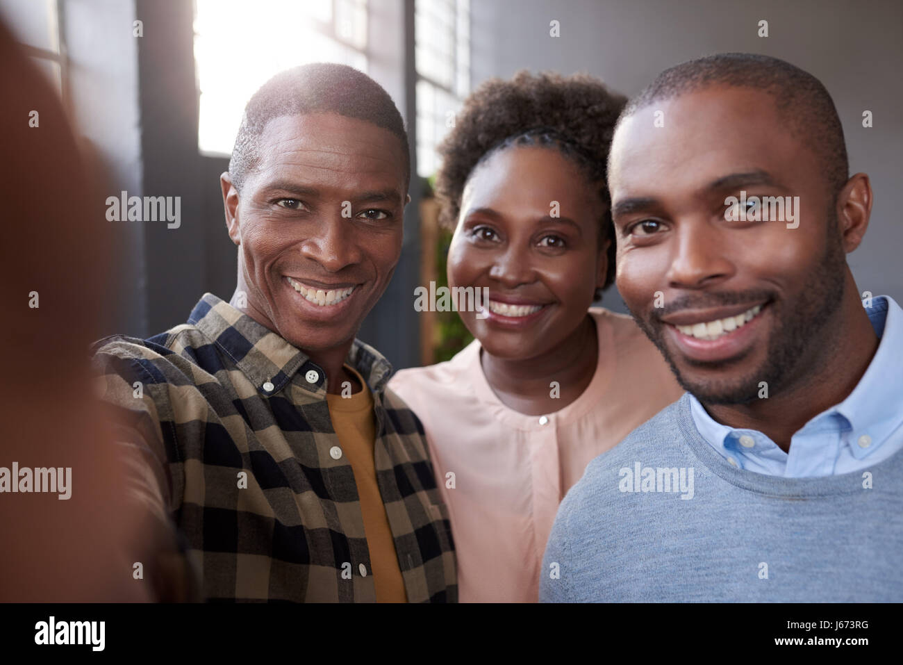 Young African work colleagues smiling together in an office Stock Photo ...