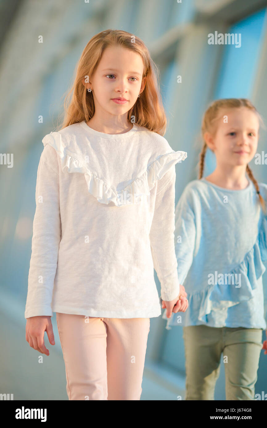 Little girls in airport while wait for their flight Stock Photo - Alamy