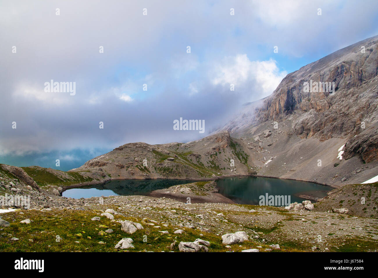 Mountain Lake in the mountains of Western Caucasus. Bright blue sky and ...