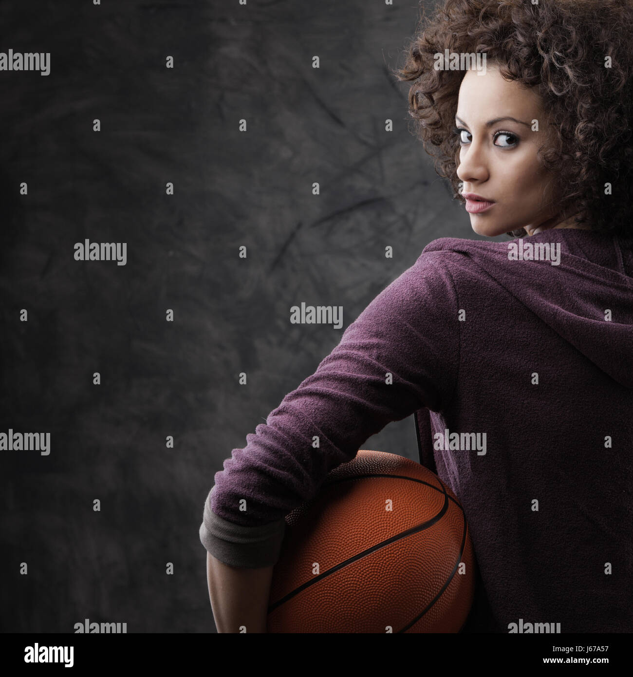 Woman holding basketball african american hi-res stock photography and ...