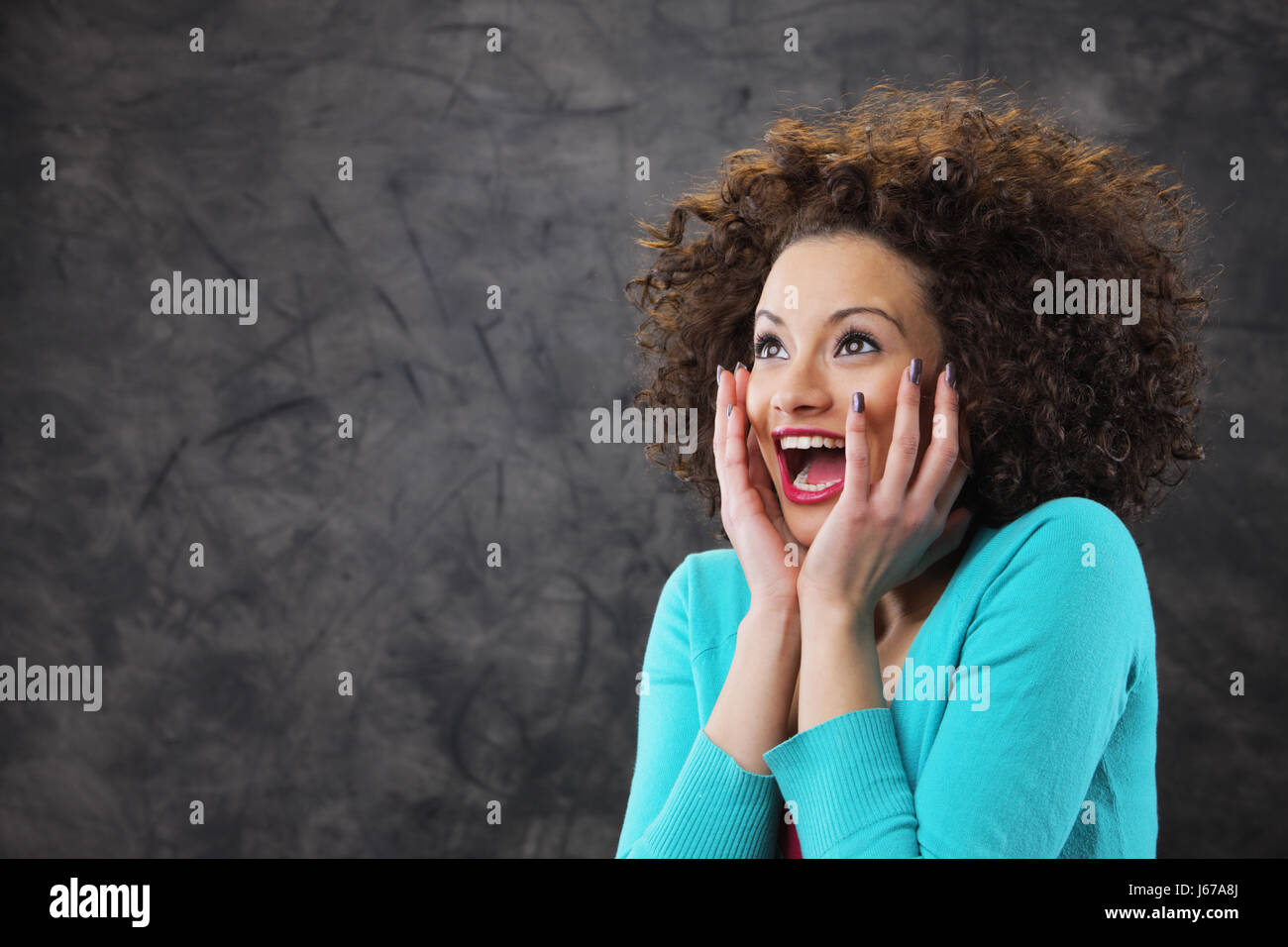 woman looks surprised and happy Stock Photo - Alamy