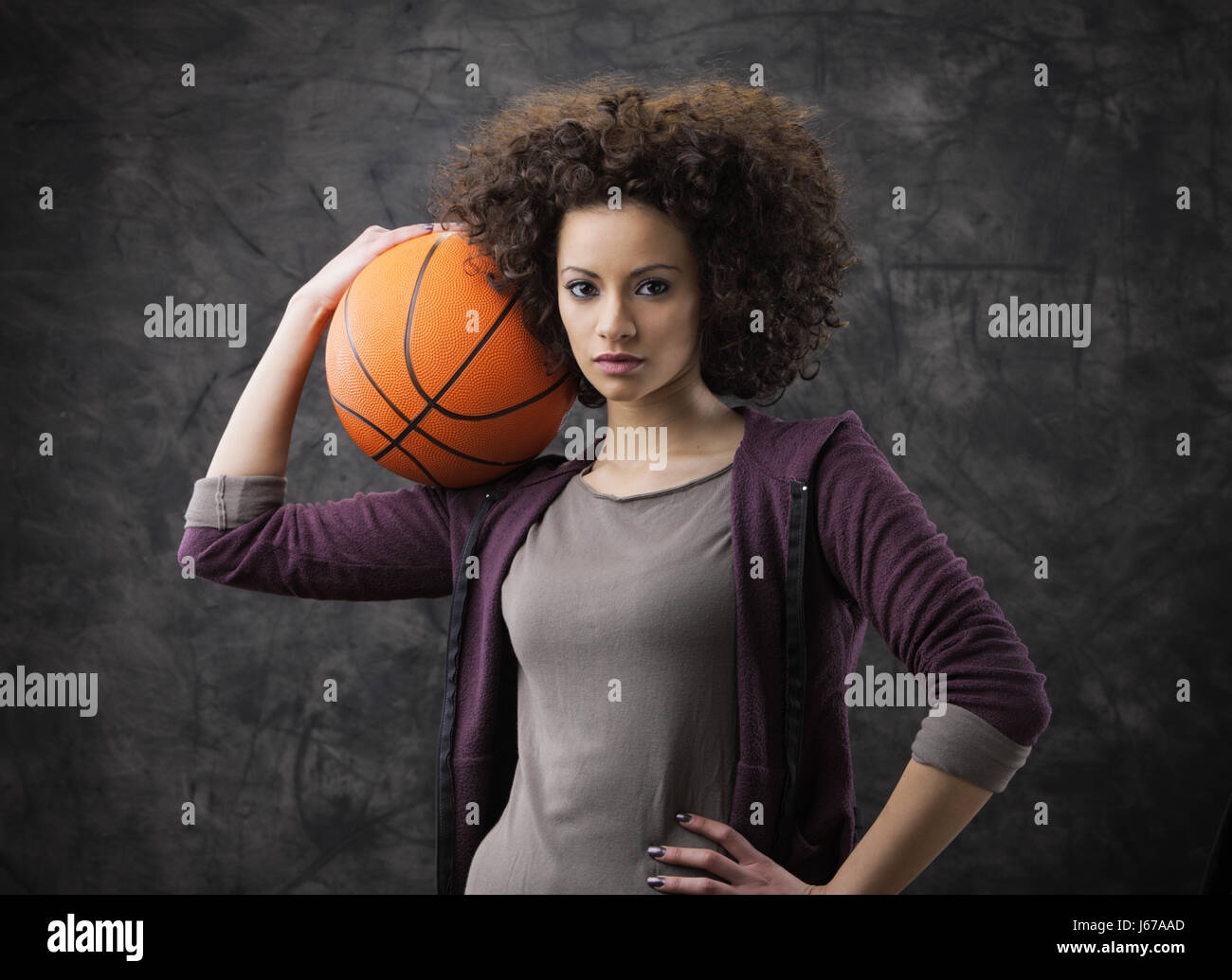 Woman holding basketball african american hi-res stock photography and ...