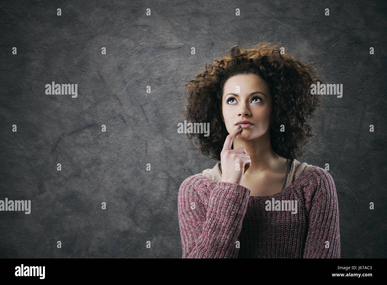 Portrait of young beautiful woman thinking Stock Photo - Alamy