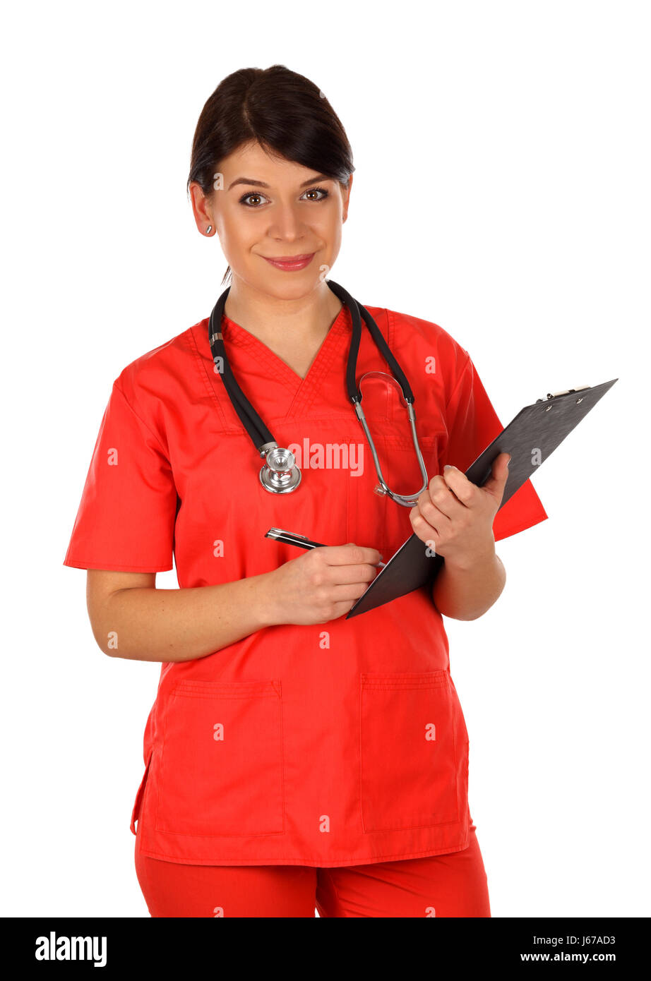 Happy young nurse standing on isolated background with a clipboard in ...