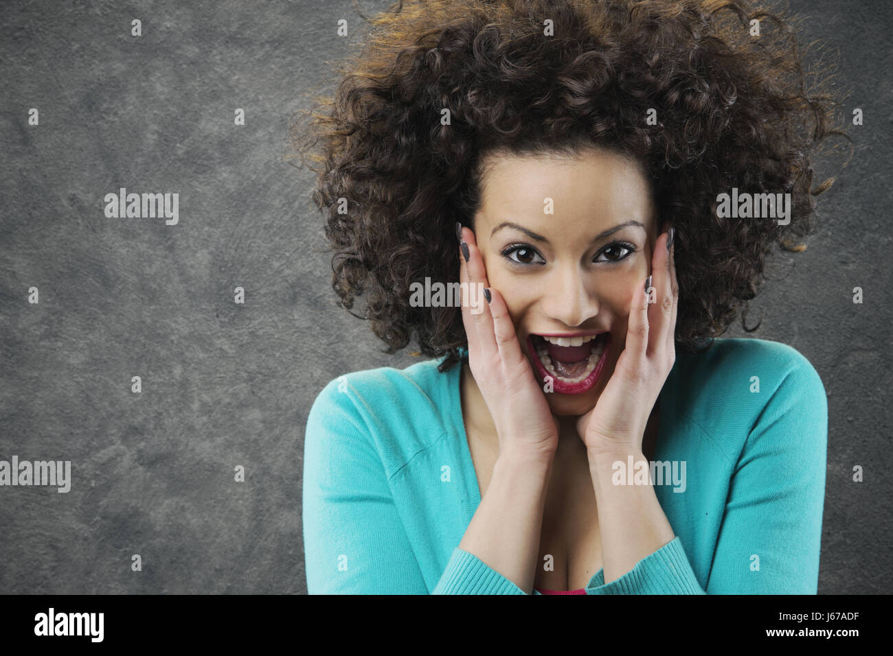 woman looks surprised and happy Stock Photo - Alamy