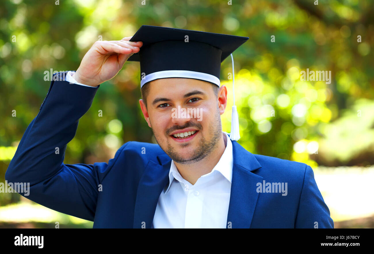 Happy graduateing student wearing graduation hat Stock Photo - Alamy