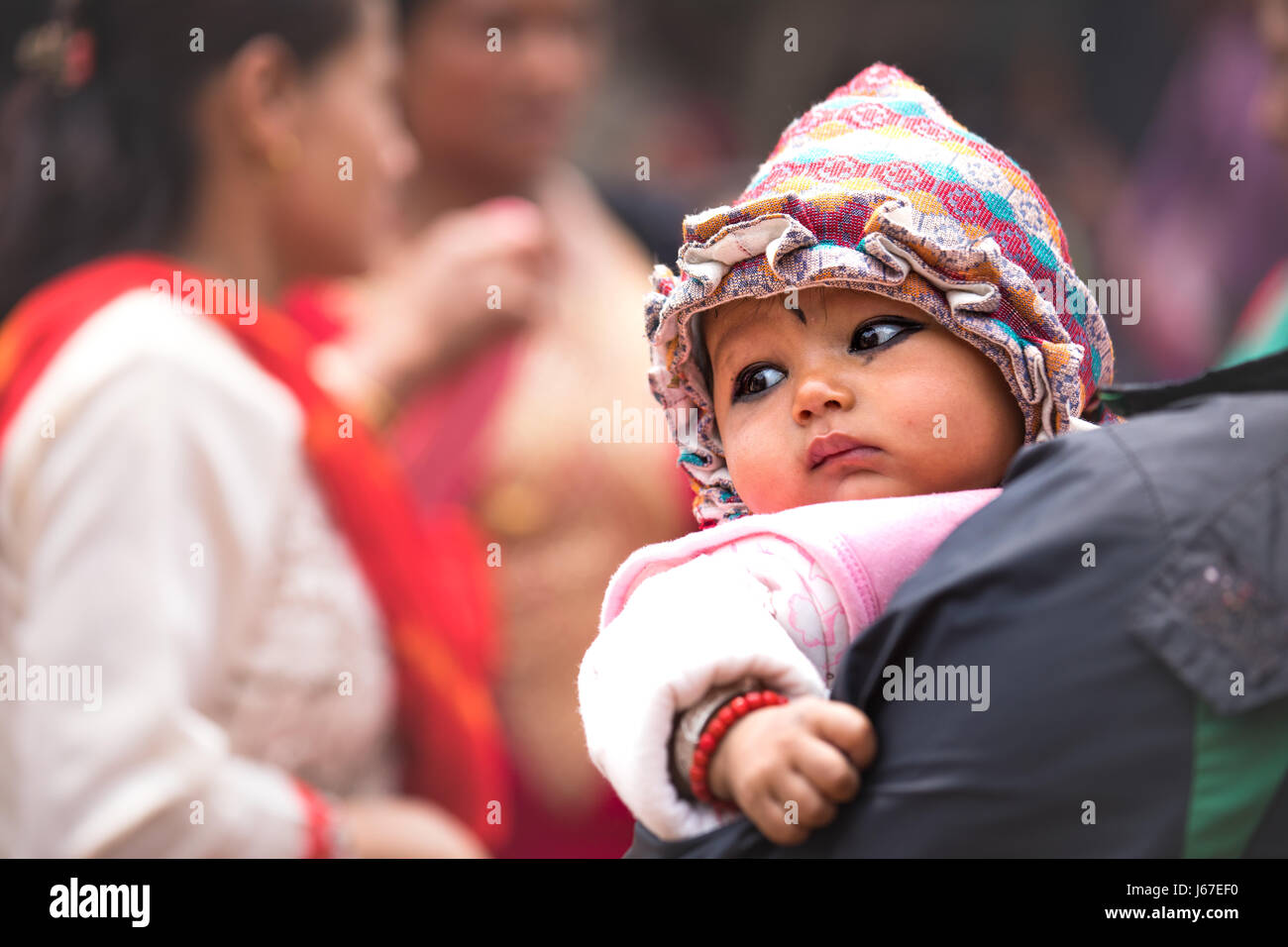 Kathmandu, Nepal - Apr 15, 2016: Father and his child watching passing ...