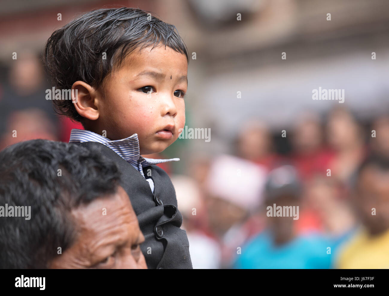 Kathmandu, Nepal - Apr 15, 2016: Father and his child watching passing ...