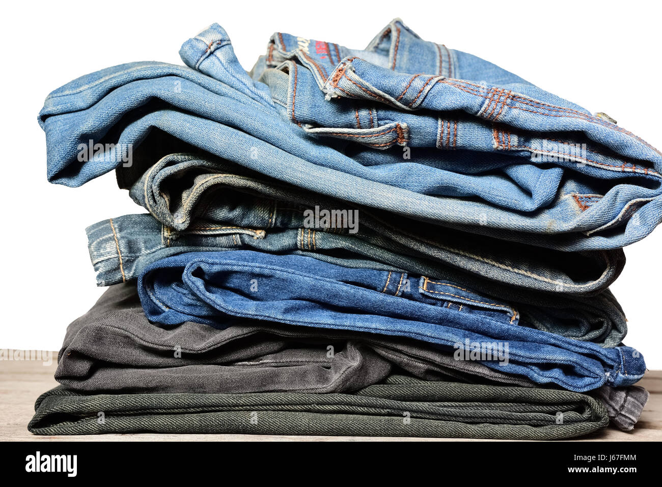 stack of blue jeans on white background Stock Photo - Alamy
