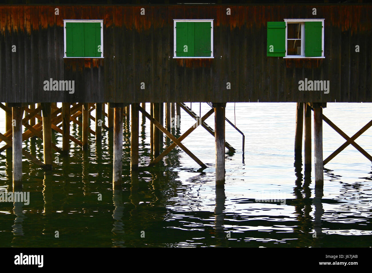 green window porthole dormer window pane wood shutters pile dwelling ...